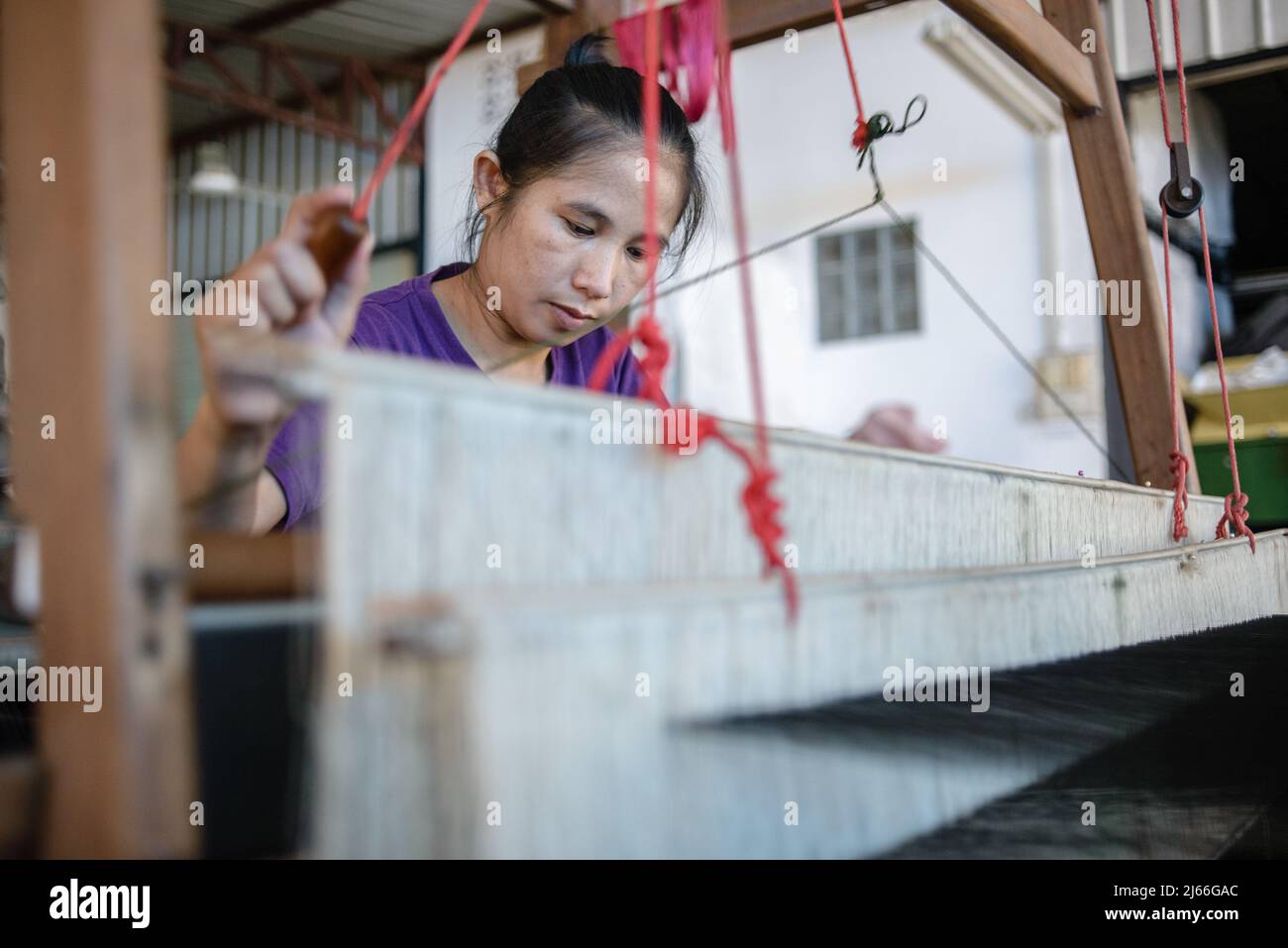 Silk weaving process at the Mai Savanh Lao workshop in Vientiane, Laos ...
