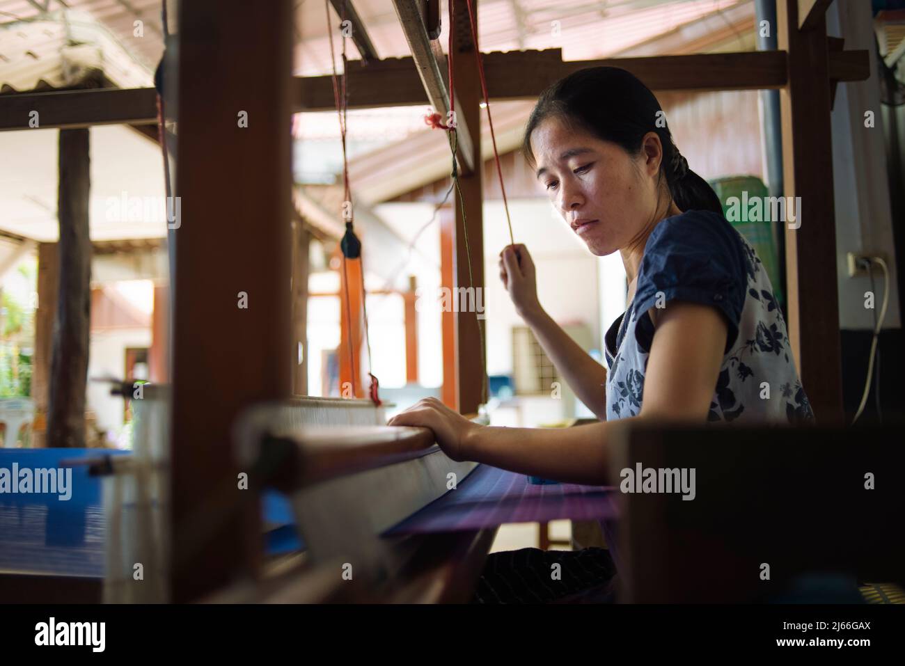 Silk weaving process at the Mai Savanh Lao workshop in Vientiane, Laos ...