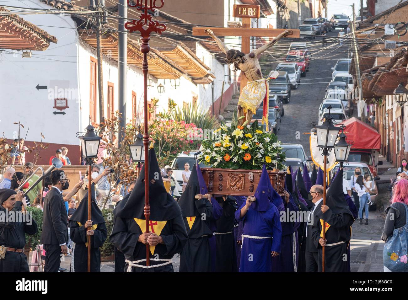 Roman Catholic hooded penitents wearing traditional capirotes, hold a ...