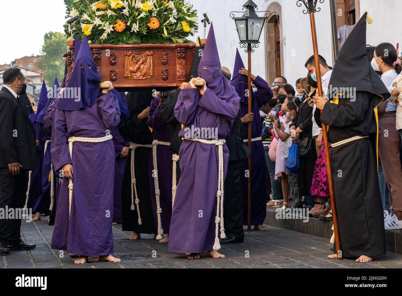Roman Catholic hooded penitents wearing traditional capirotes, carry a ...