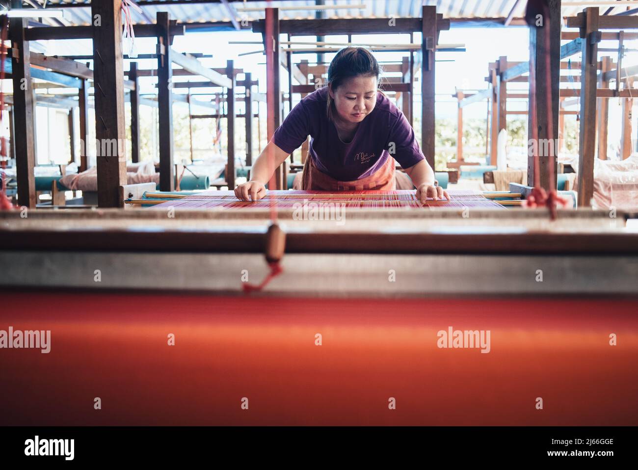 Silk weaving process at the Mai Savanh Lao workshop in Vientiane, Laos ...