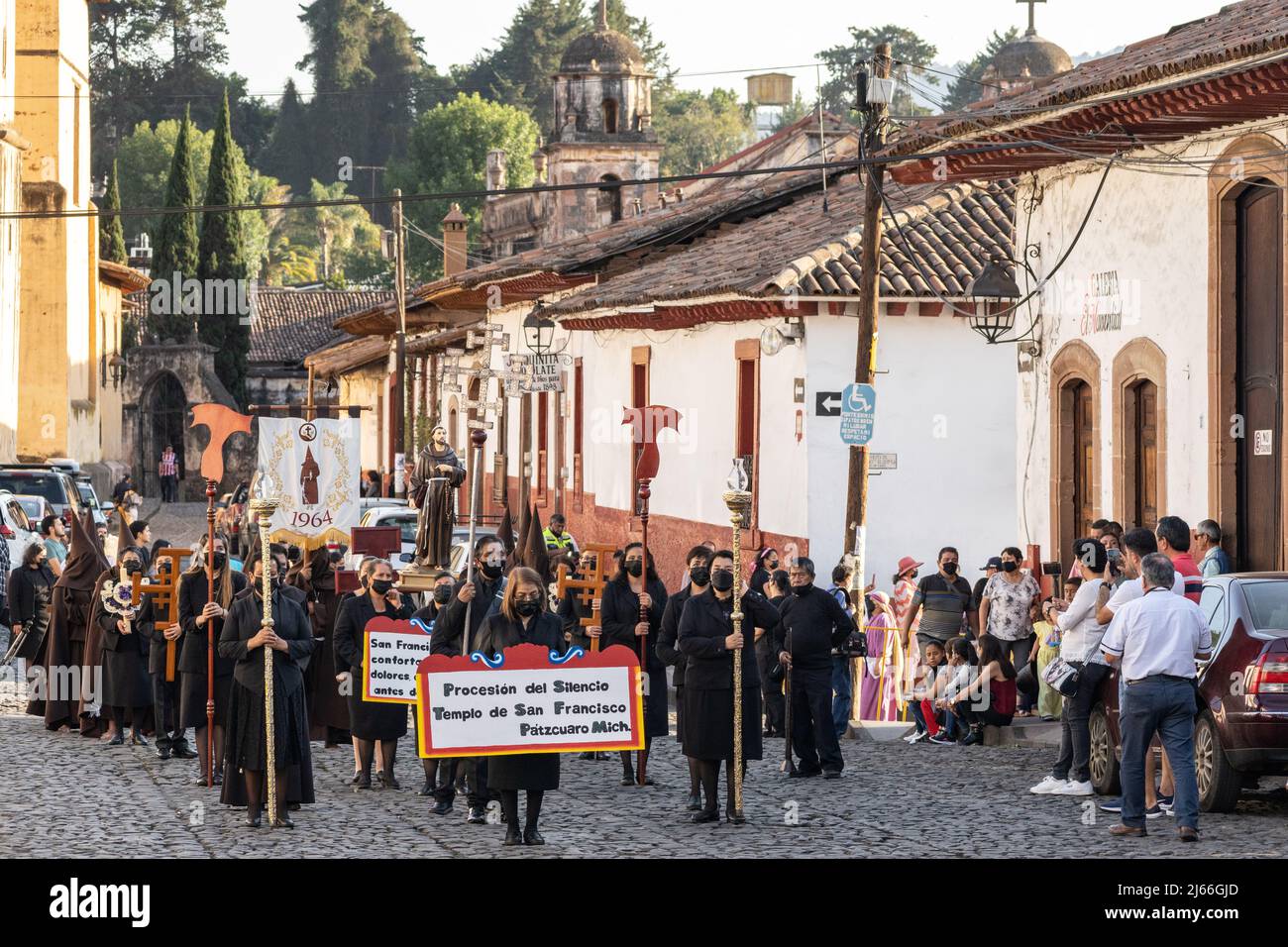 Roman Catholic hooded penitents wearing traditional capirotes, carry a ...