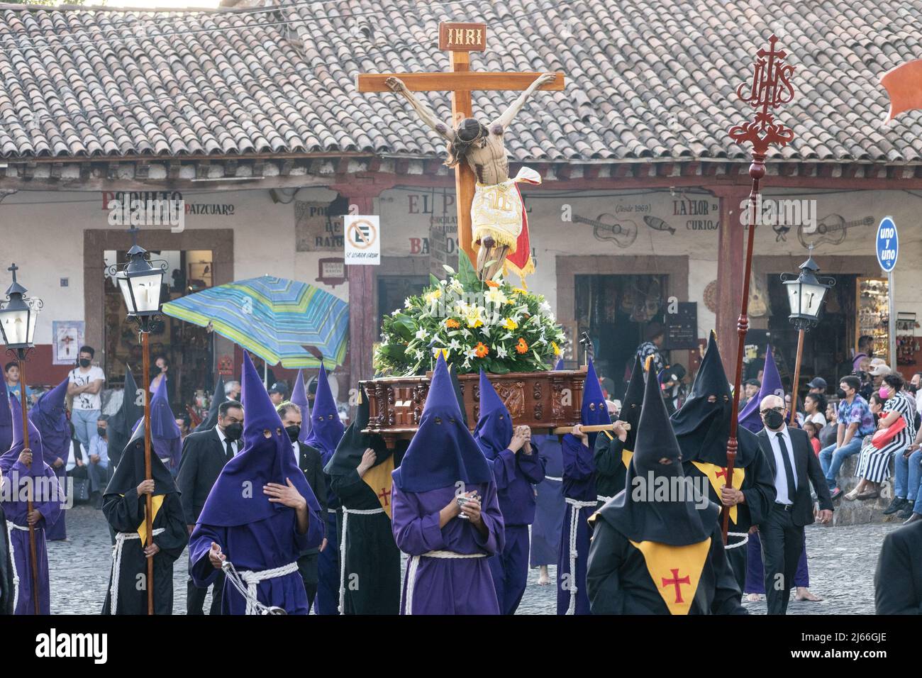 Roman Catholic hooded penitents wearing traditional capirotes, carry a ...