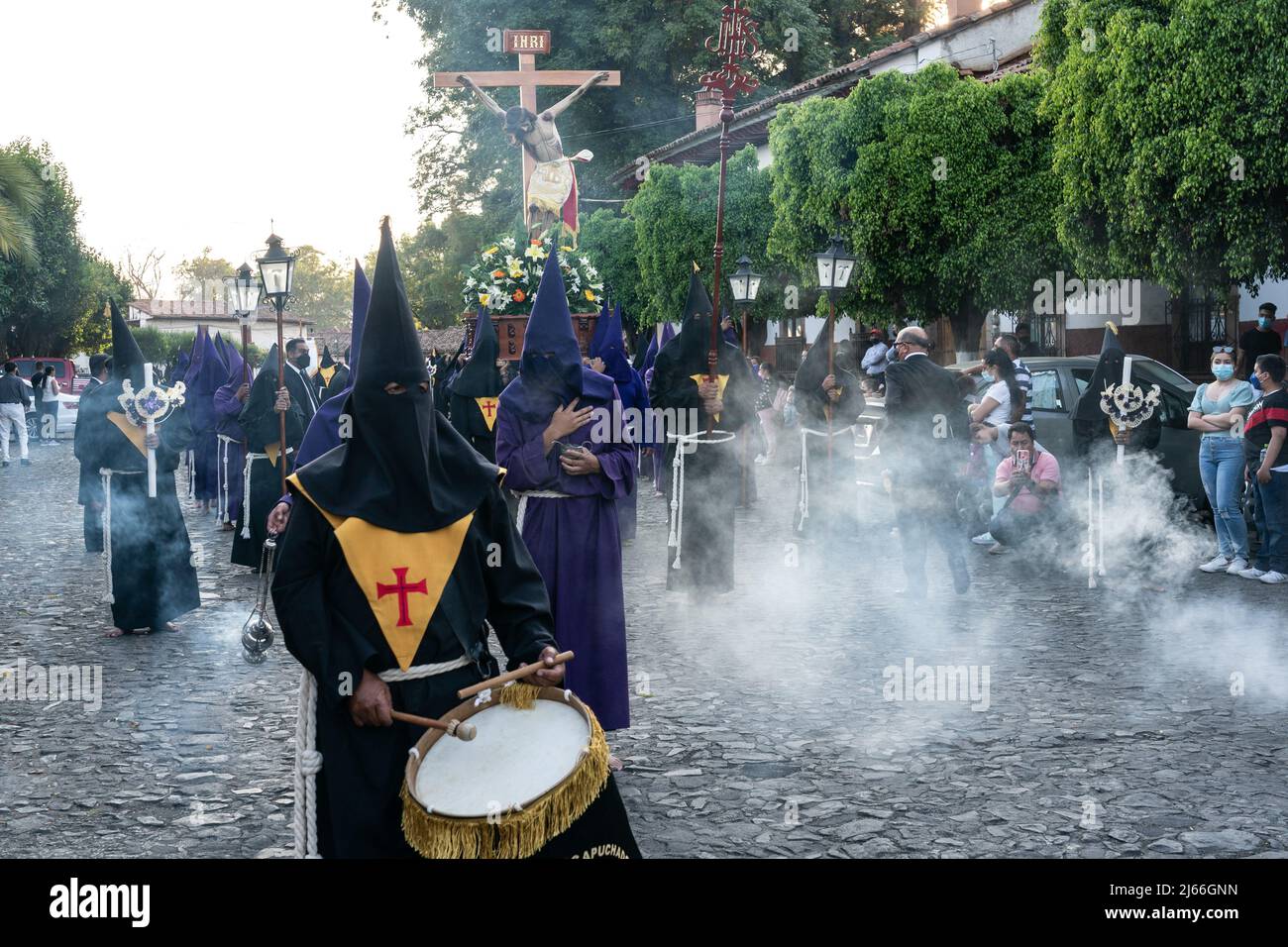 Roman Catholic hooded penitents wearing traditional capirotes, carry a ...