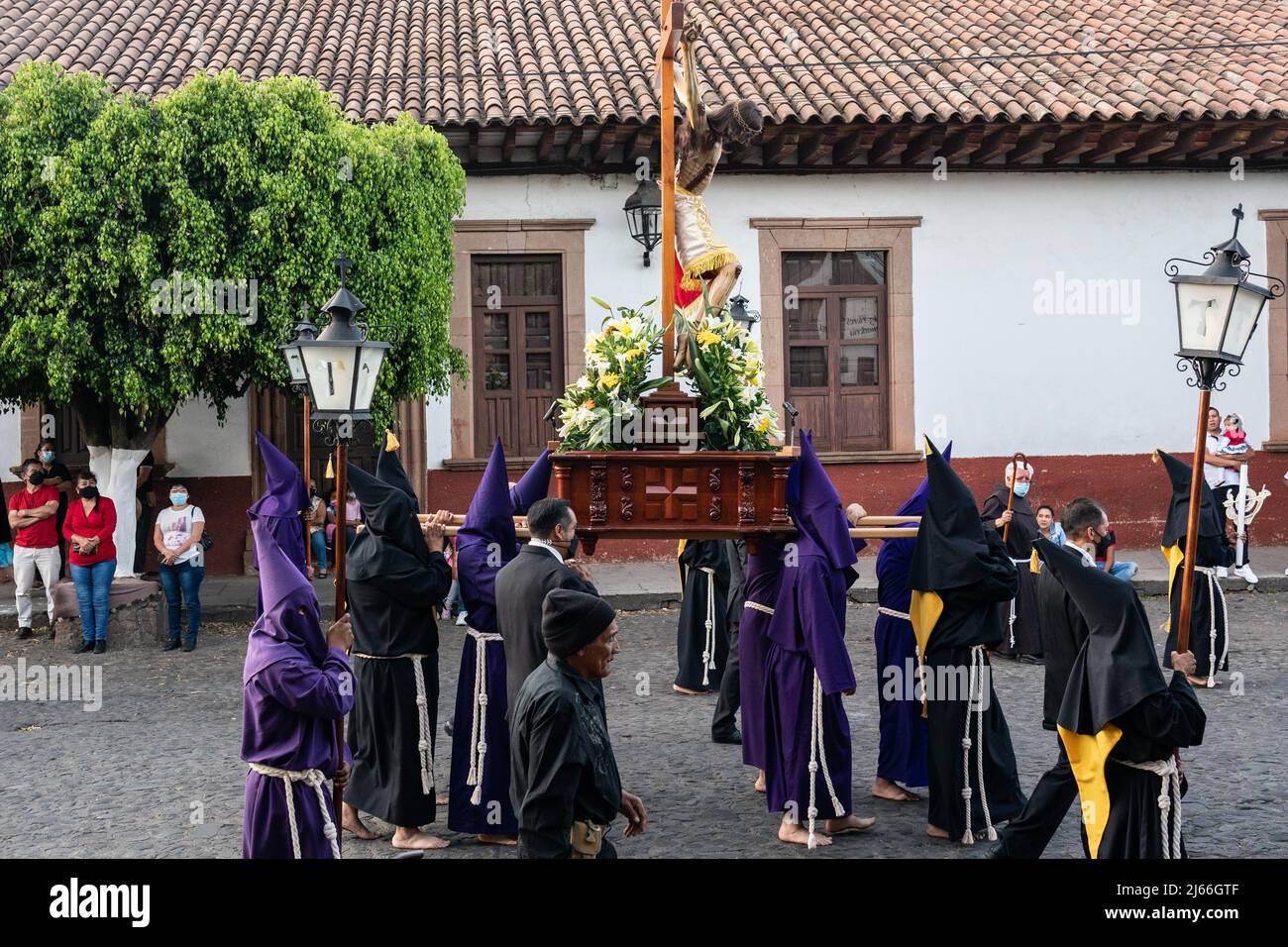 Roman Catholic hooded penitents wearing traditional capirotes, carry a ...