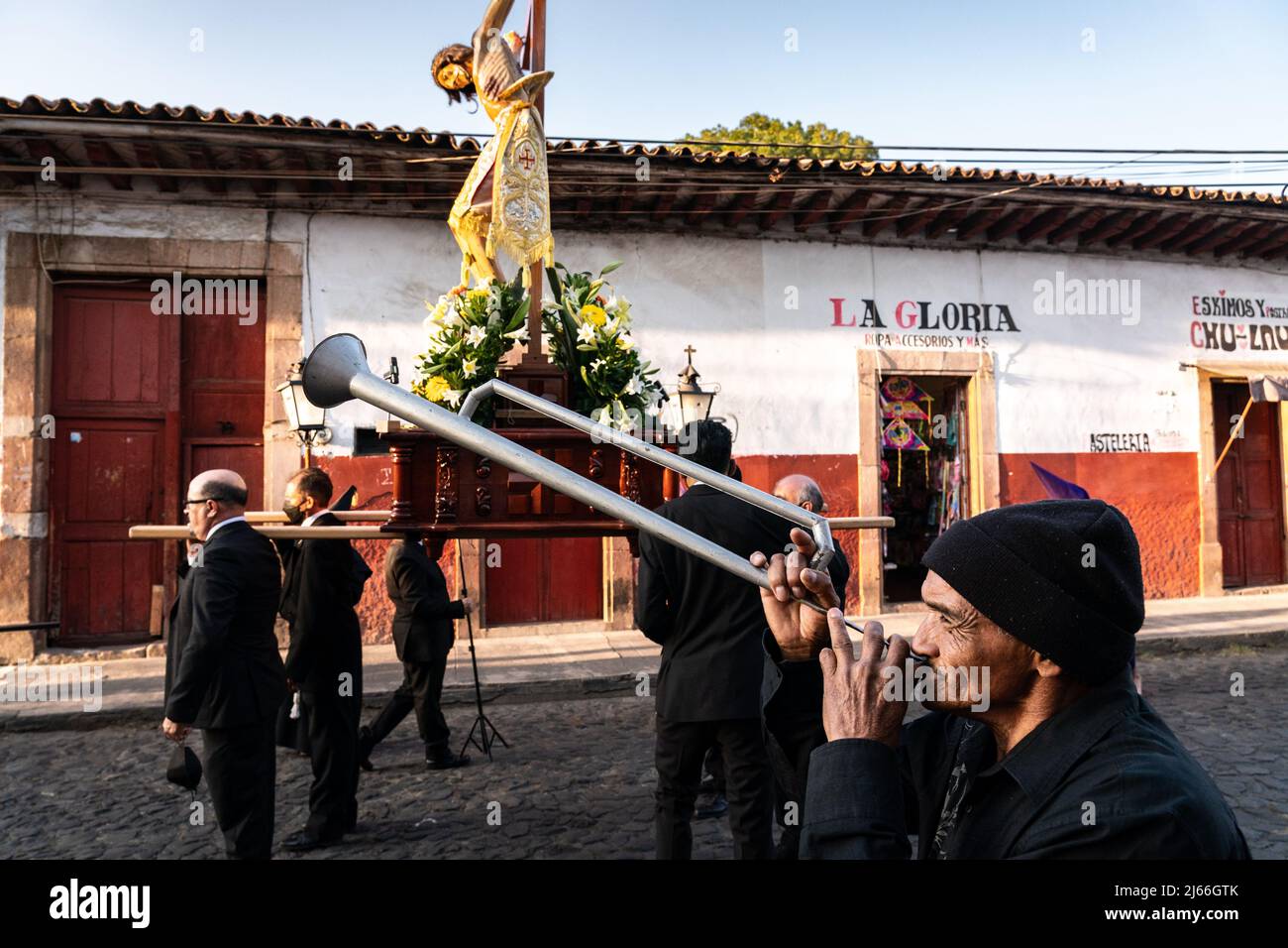 A member of the Roman Catholic brotherhood blows a horn to announce the ...