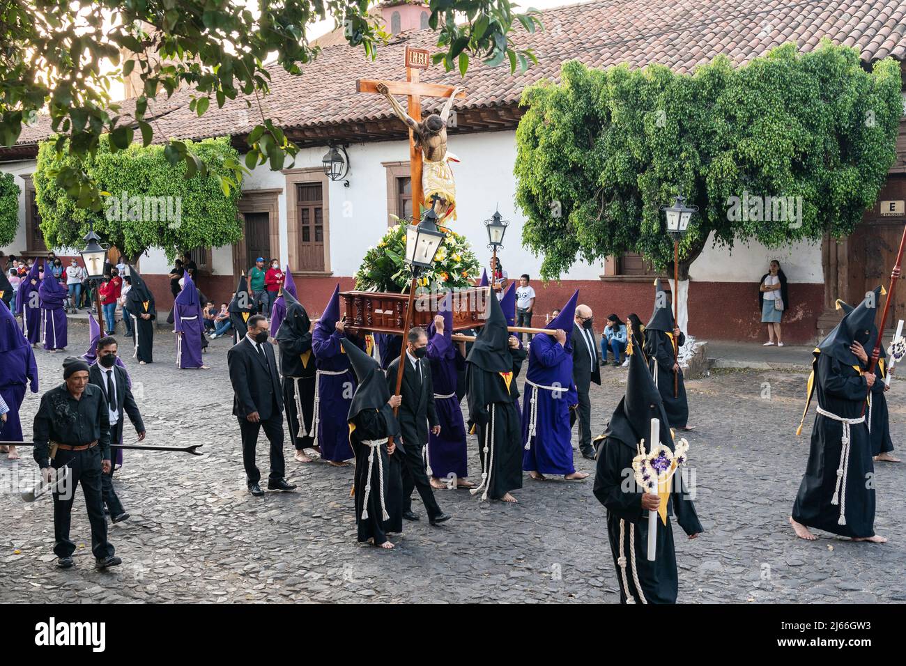 Roman Catholic hooded penitents wearing traditional capirotes, carry a ...