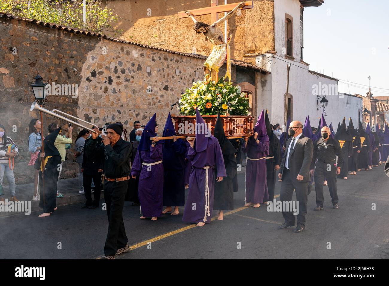 Roman Catholic hooded penitents wearing traditional capirotes, carry a ...