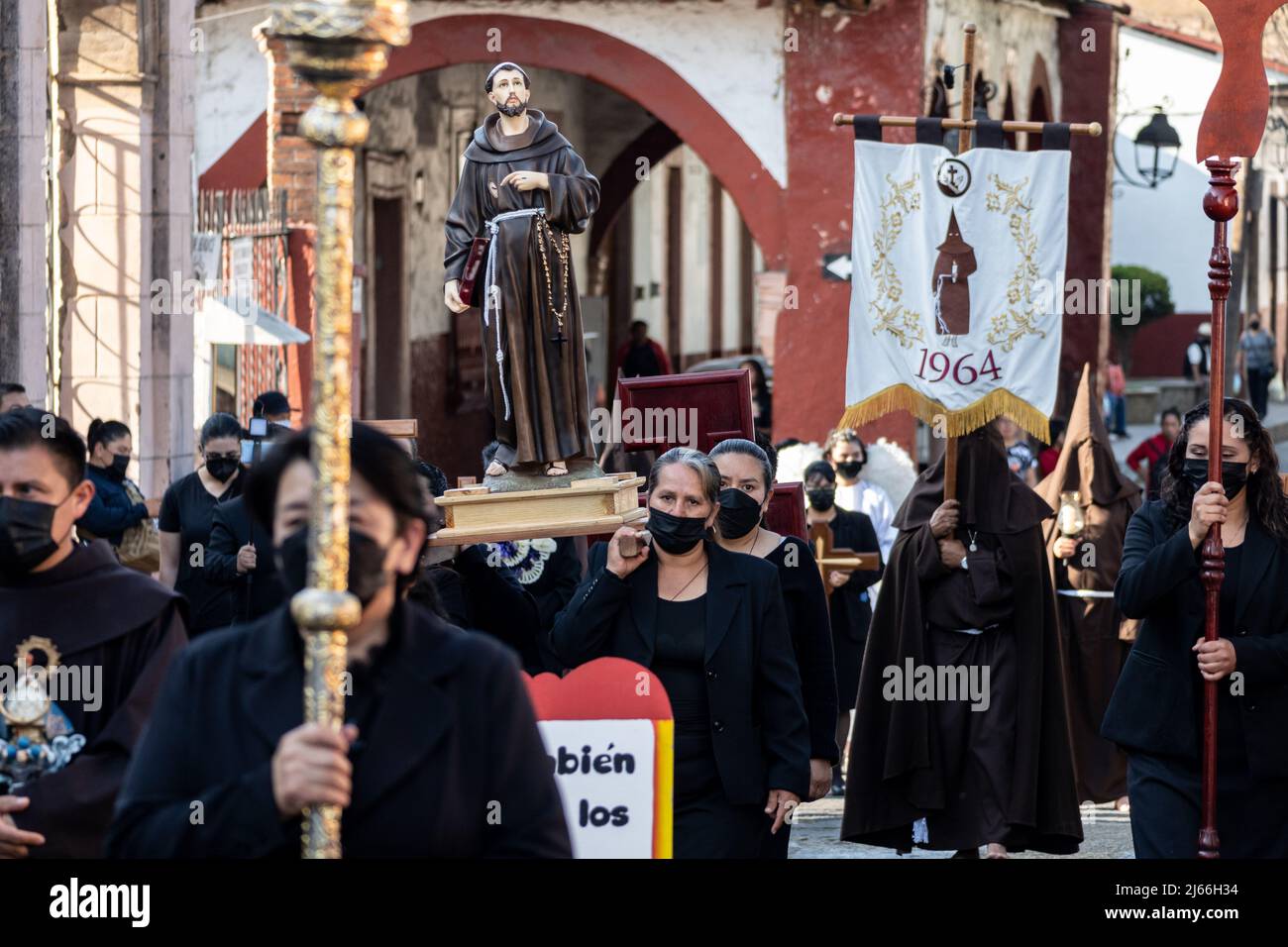 A society of Roman Catholic women joined by hooded penitents wearing ...