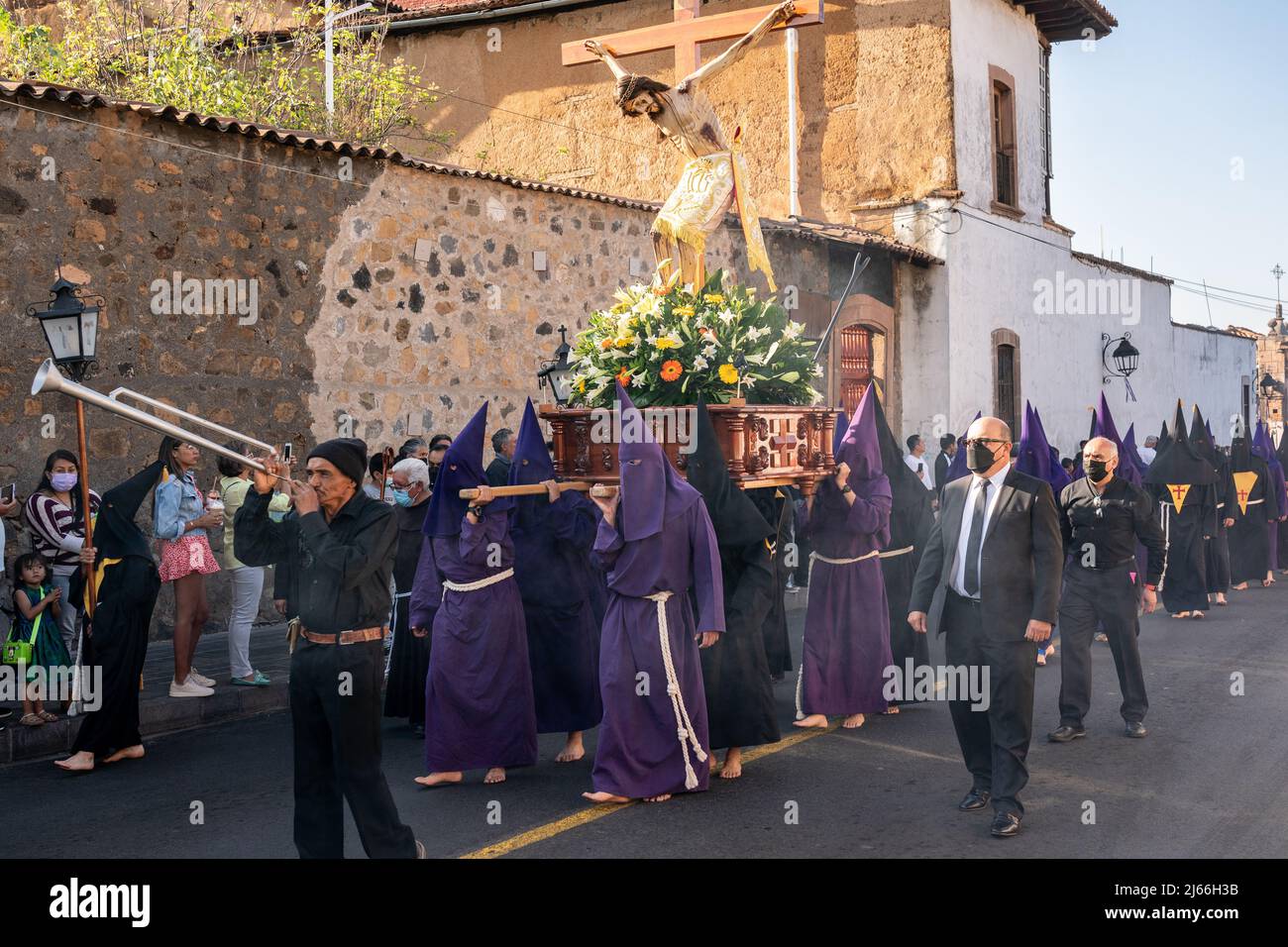 Roman Catholic hooded penitents wearing traditional capirotes, carry a ...