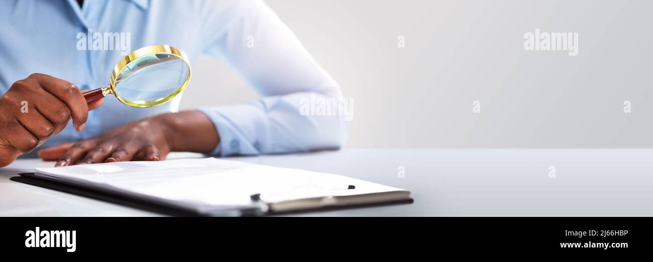 Close-up Of A Businessperson's Hand Looking At Contract Form Through ...