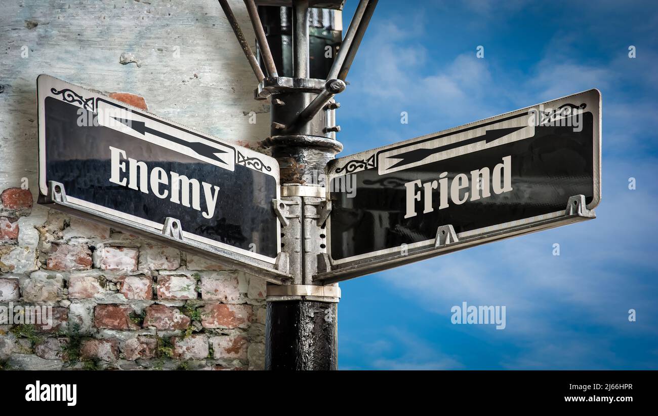 Street Sign the Direction Way to Friend versus Enemy Stock Photo - Alamy