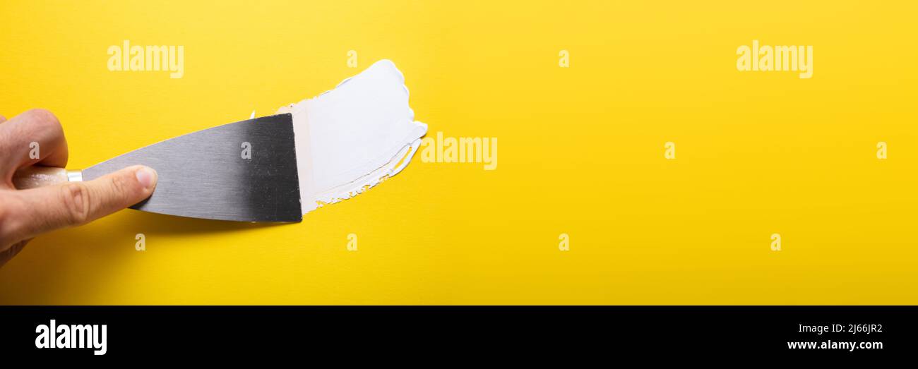 Close-up Of Painter's Hand Puttied Wall Using A Paint Trowel Stock ...