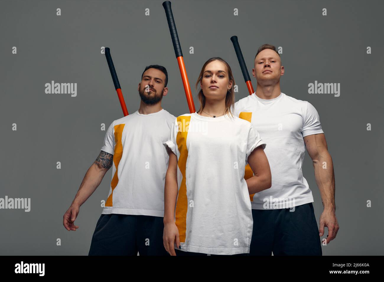 People stand together and practice sticks. Karate masters posing with ...
