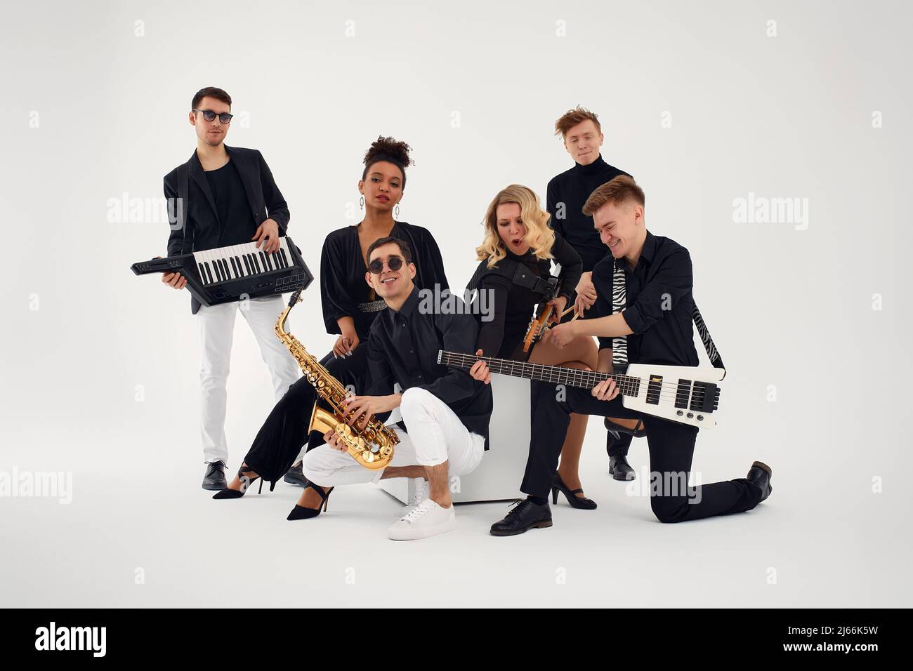 Portrait of diverse group of young people musical band playing with ...