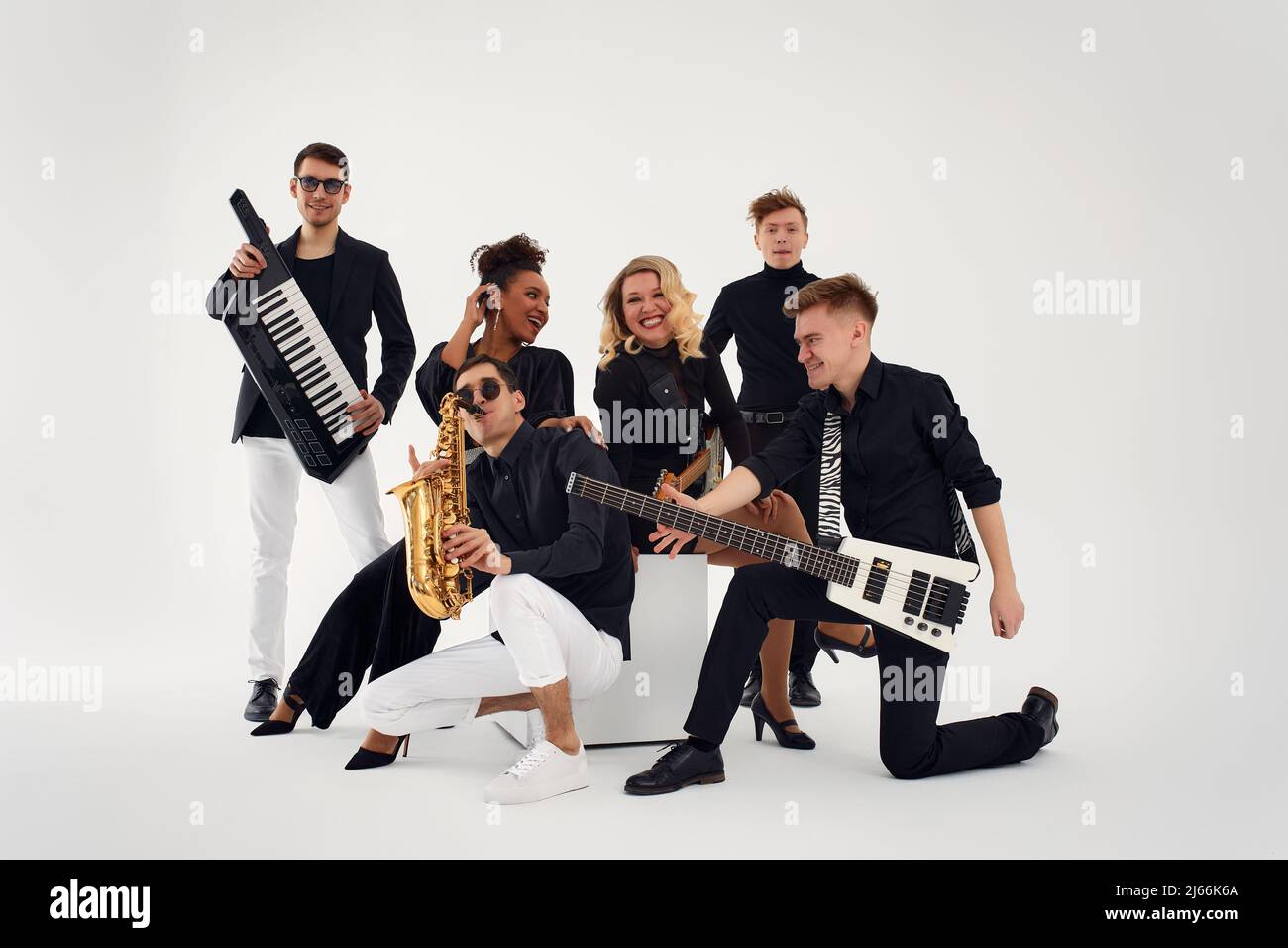 Portrait of diverse group of young people musical band playing with ...
