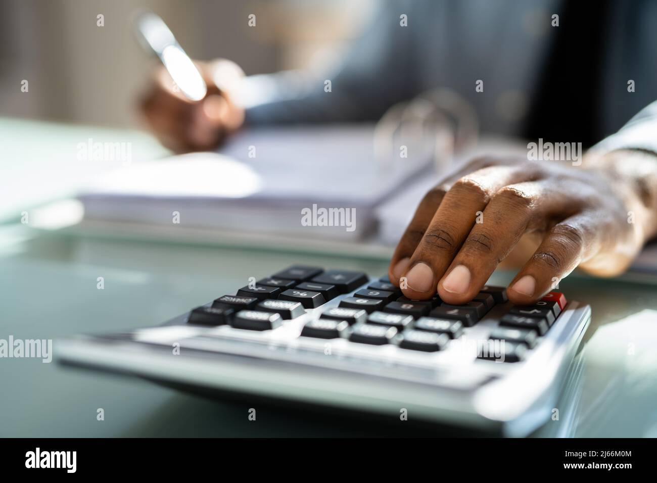 African American Male Accountant Using Calculator For Accounting Stock ...