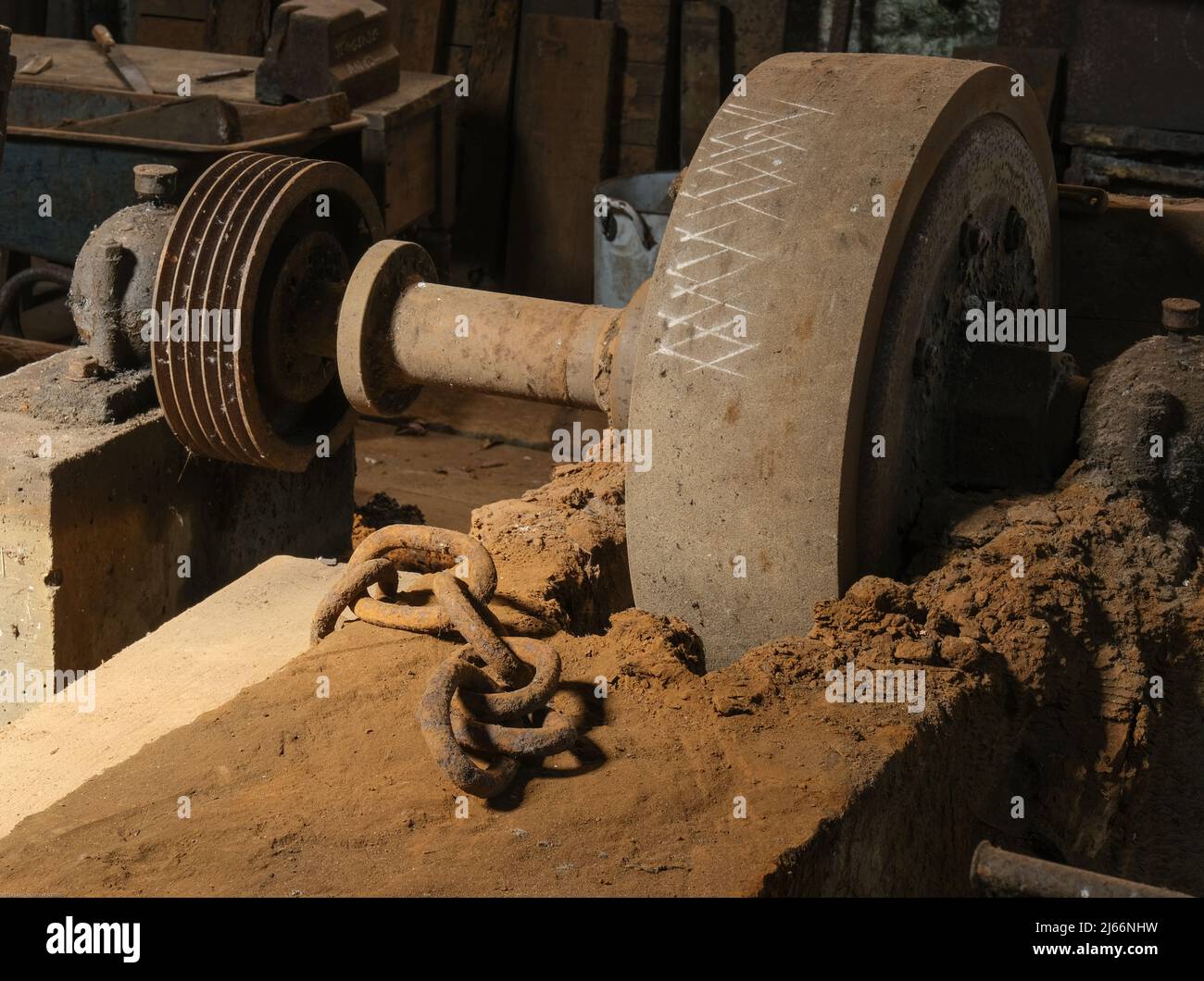 Rusted iron chains and old iron grinding wheel on display in Abbeydale ...