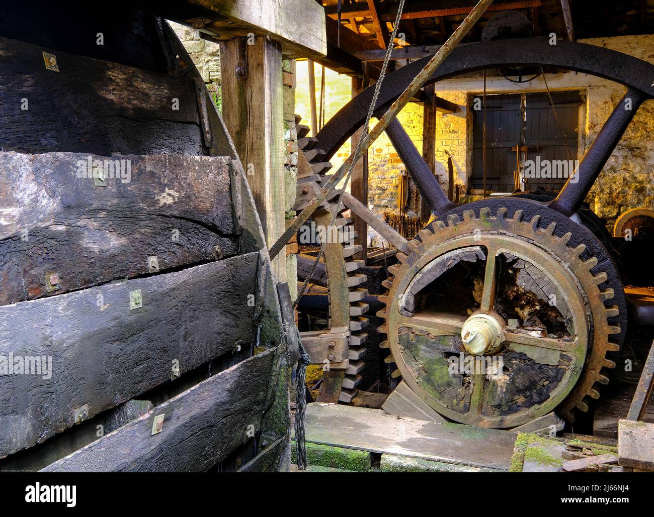 Giant rusted cog wheels rest beside an old water wheel in Abbeydale ...