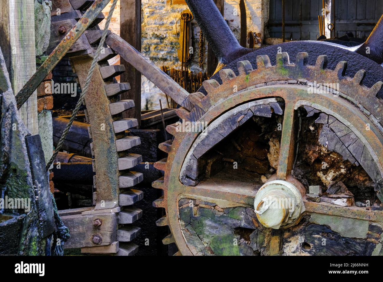 Giant rusted cog wheels rest beside an old water wheel in Abbeydale ...