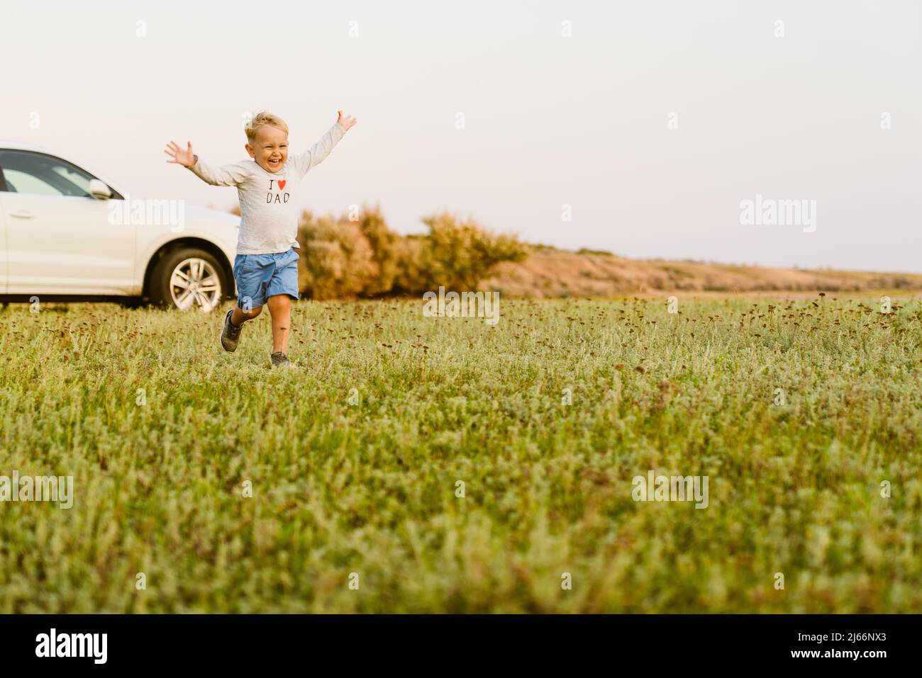 Blonde boy running hi-res stock photography and images - Alamy