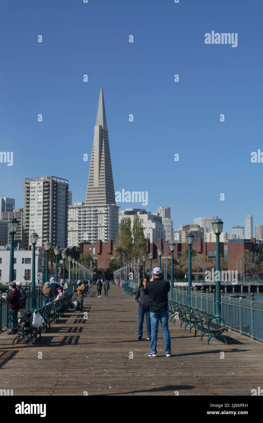 Tourists enjoy the popular Pier 7 fishing pier with its distant view of ...