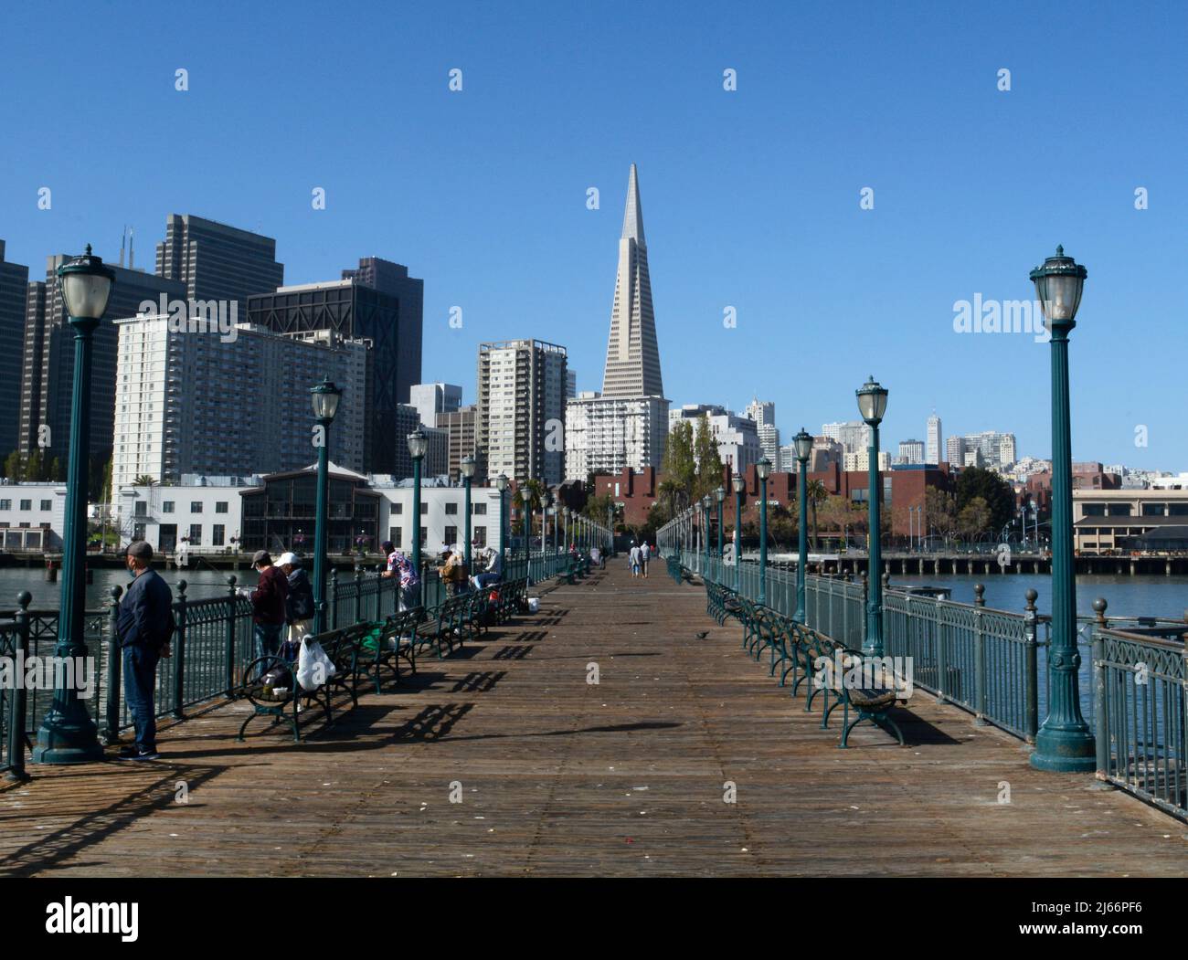 Tourists enjoy the popular Pier 7 fishing pier with its distant view of ...