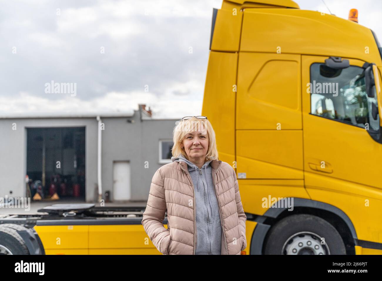 Caucasian mid age woman driving truck. trucker female worker, transport ...