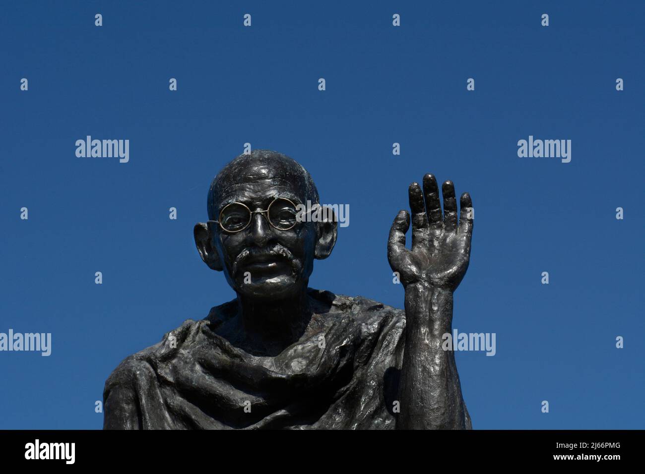 A bronze statue of Indian leader Mahatma Gandhi stands along the ...