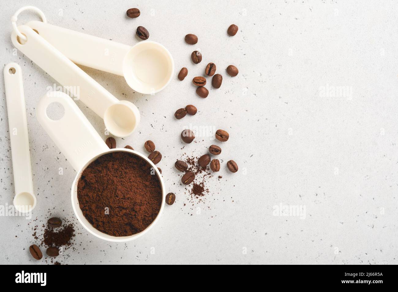 Coffee background. Measuring spoons with ground coffee and beans on old ...