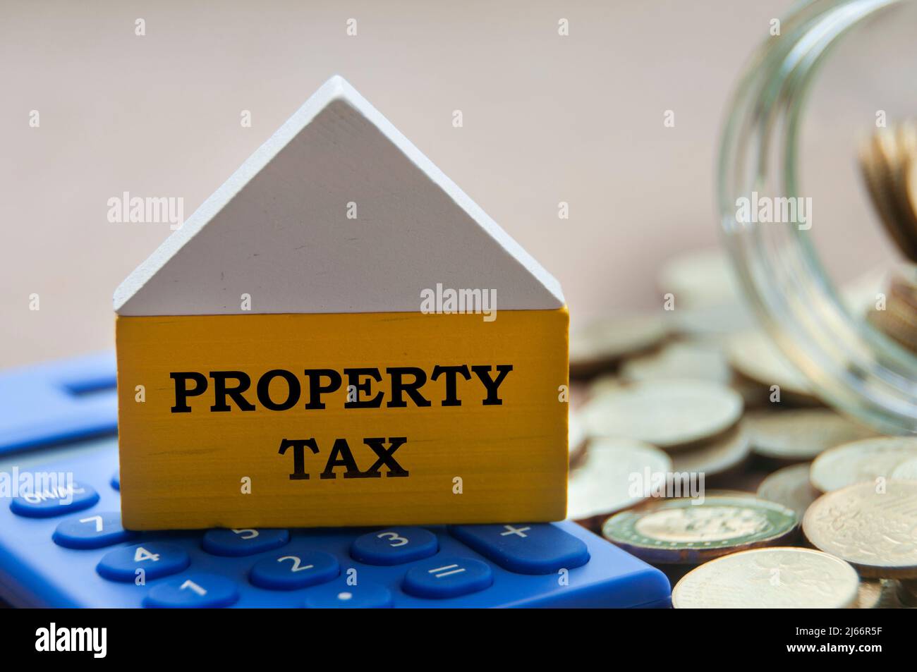 Property tax on wooden model house with calculator and gold coins Stock ...