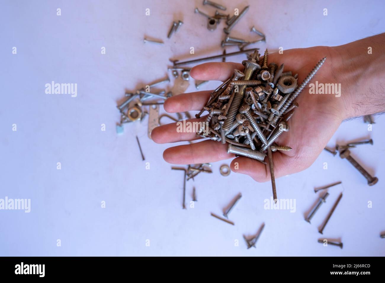 Man hand holding pile of rusty nails and nuts, top view, laydown ...