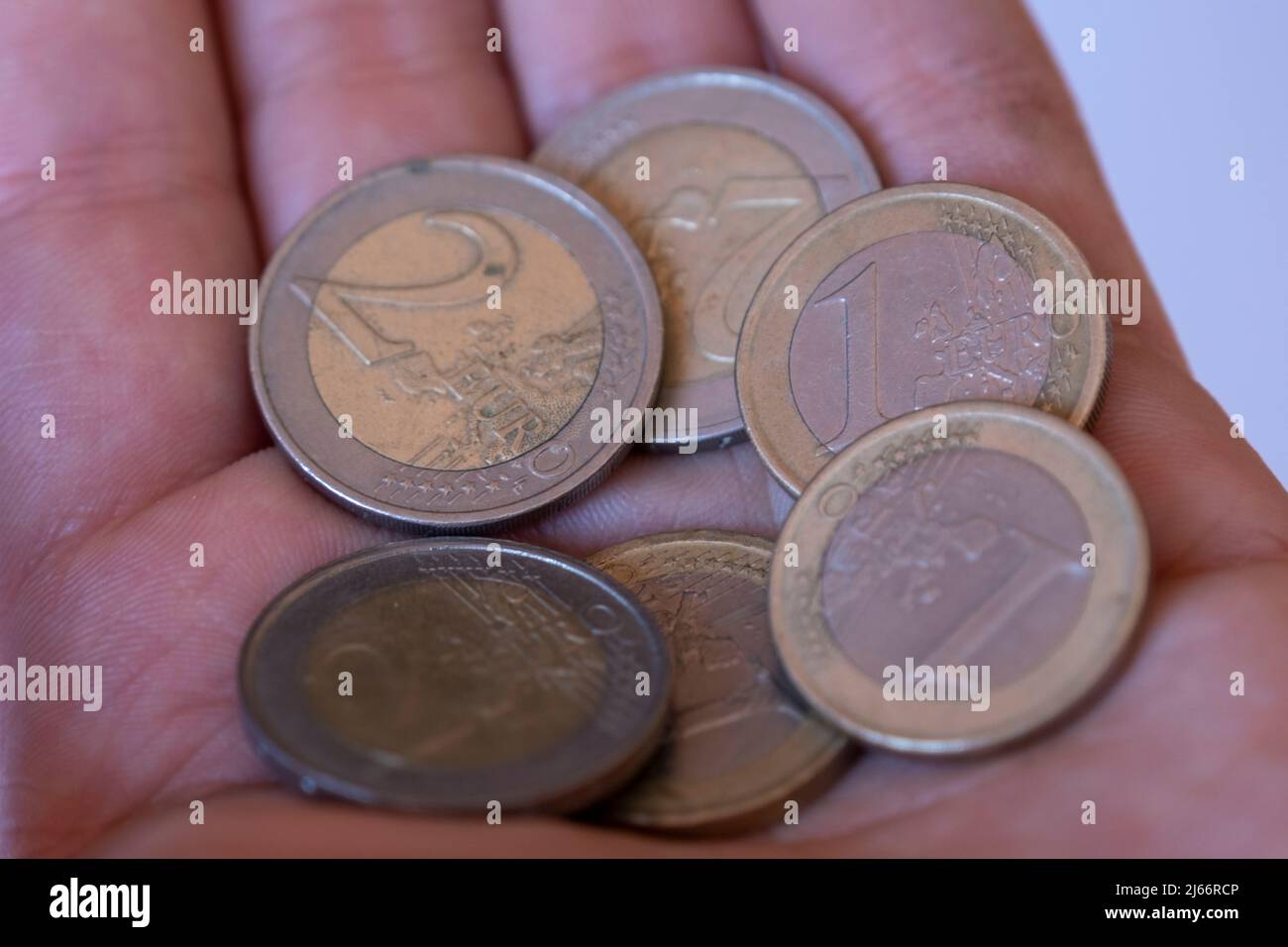 Coins on male hand, close-up side view, saving money concept, metal ...