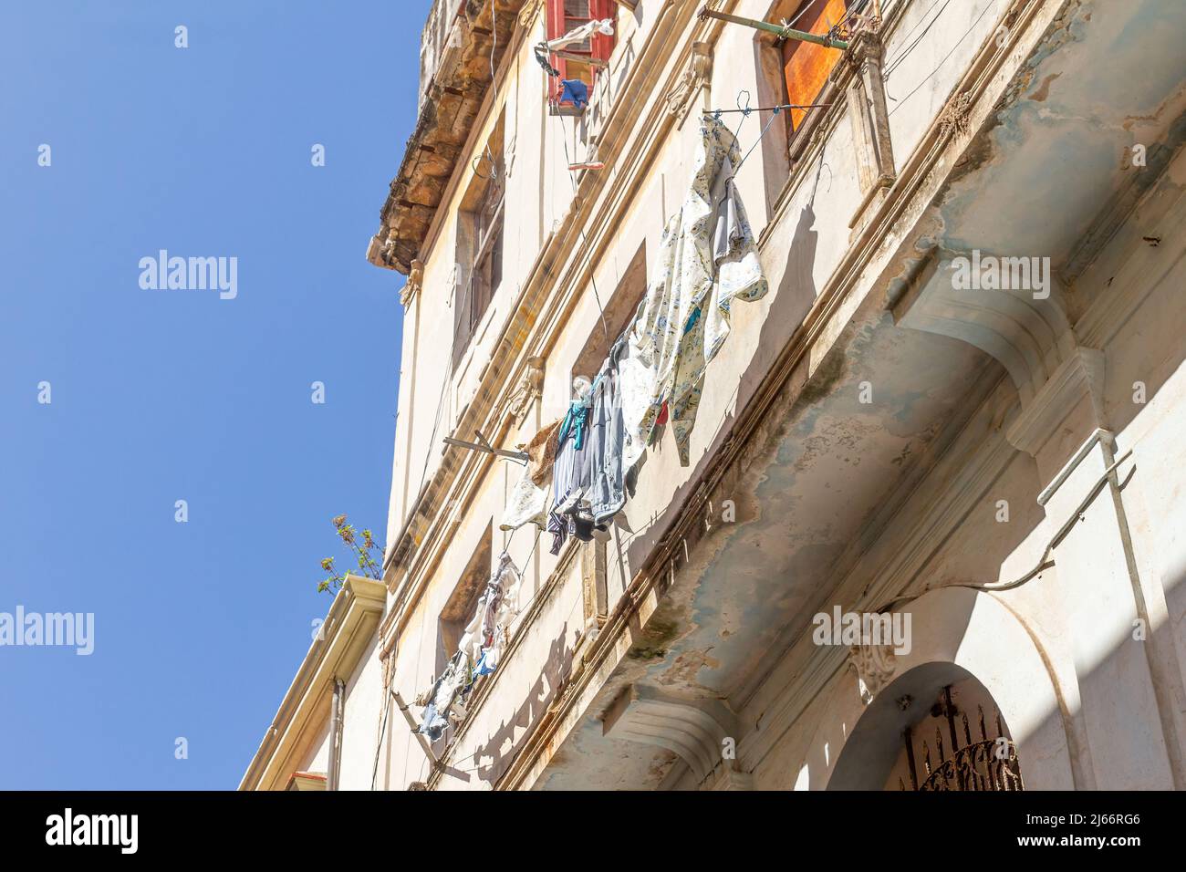 Facade of an old weathered and run-down apartment building in the ...