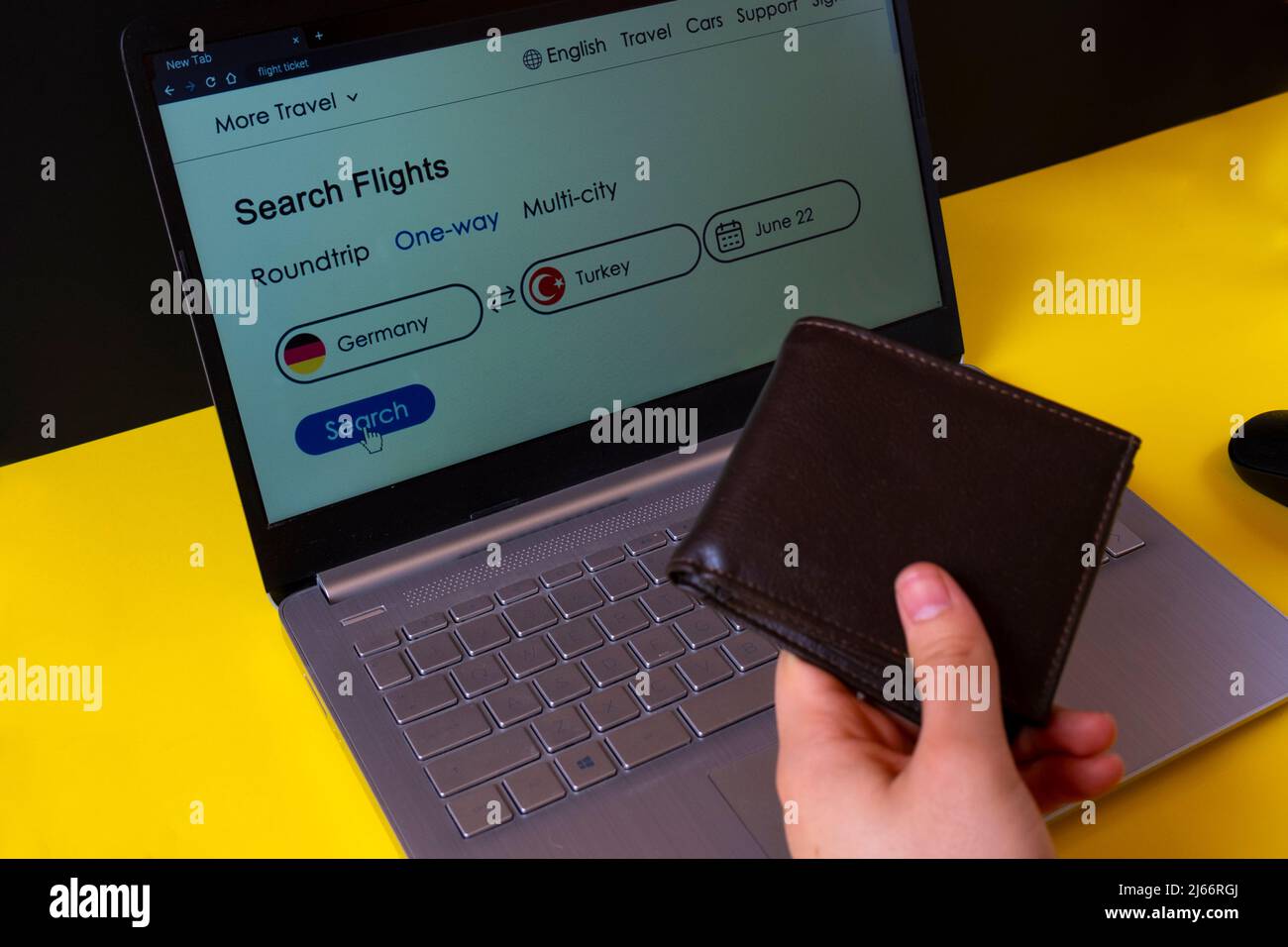 Man hand holding wallet with flight ticket screen on background ...