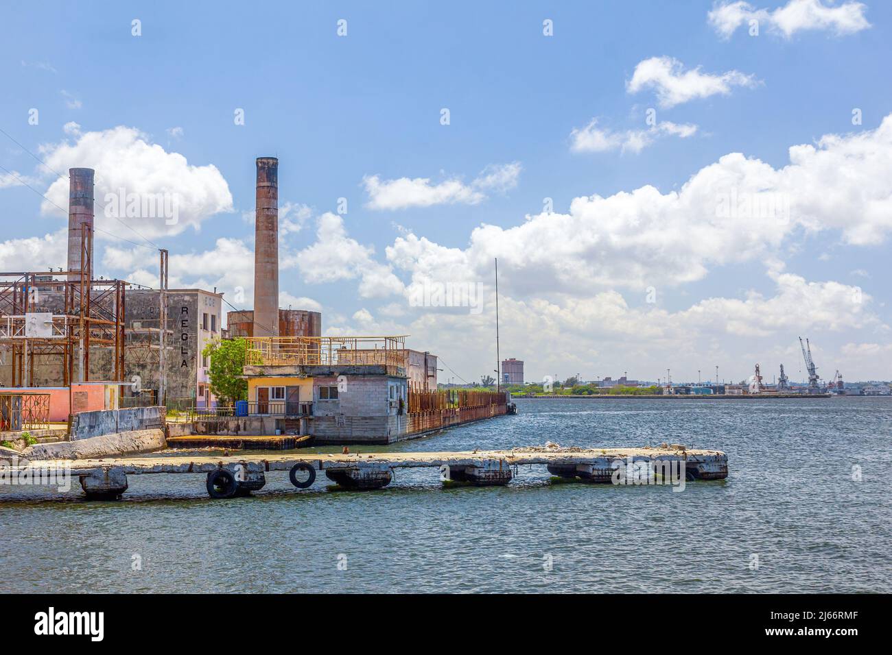 Havana bay coastal feature. An old run-down factory is seen behind a ...