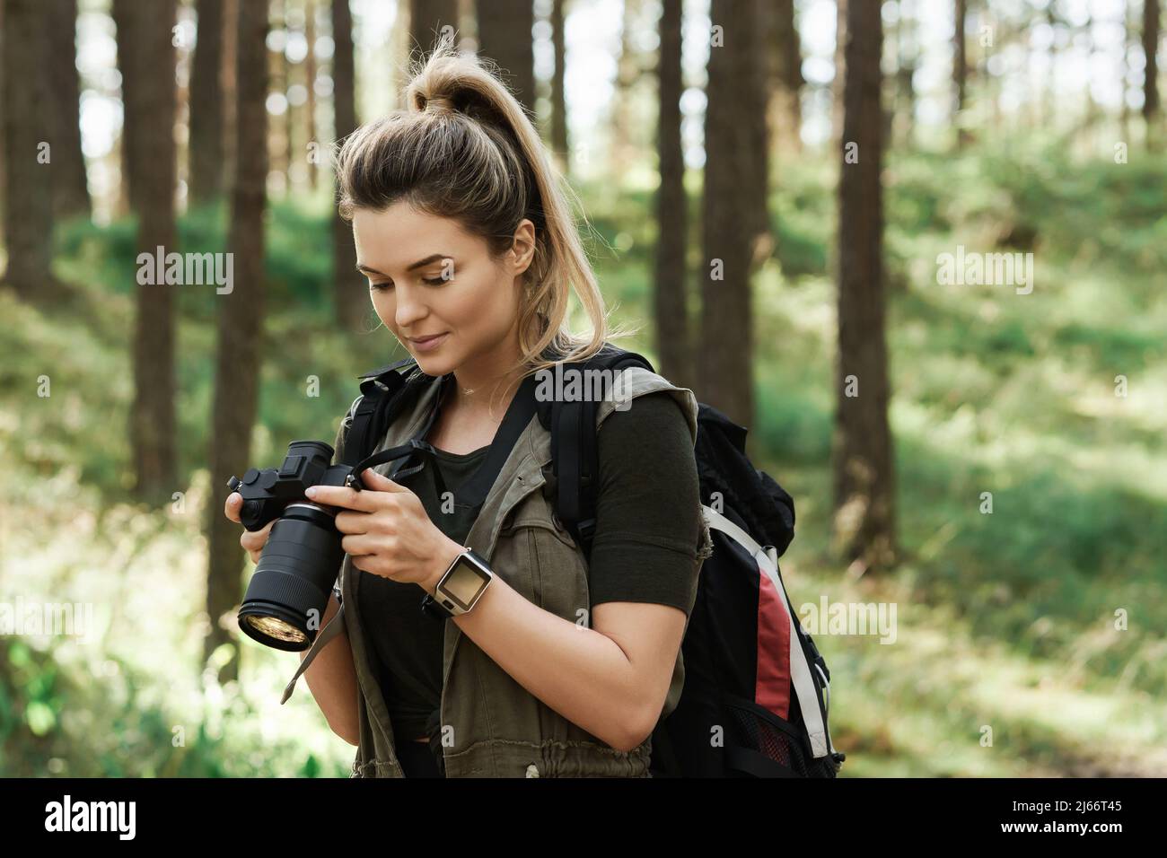 Hiker using modern mirrorless camera in green forest Stock Photo - Alamy