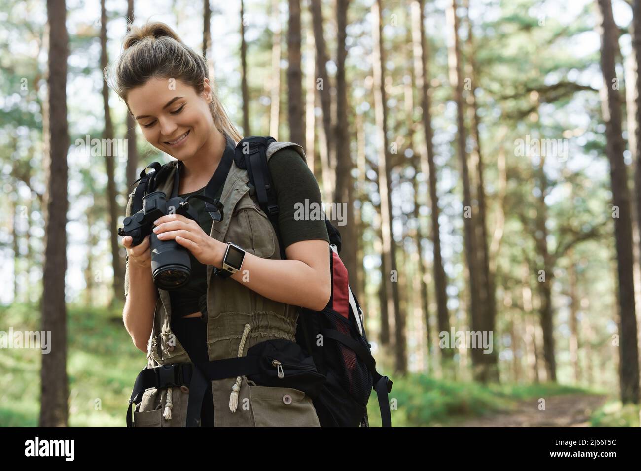 Hiker using modern mirrorless camera in green forest Stock Photo - Alamy