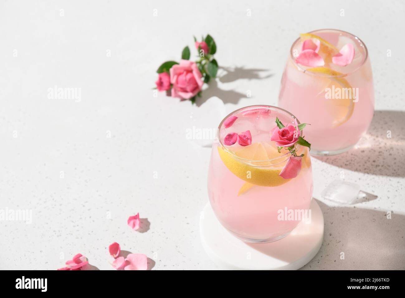 Pink rose cocktails, drinks or lemonade with rose flowers on white ...