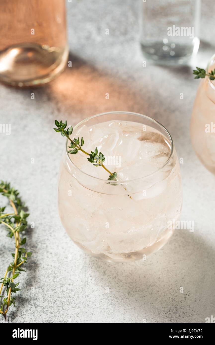 Boozy Pink Rose Wine Spritzer with Ice and Thyme Stock Photo - Alamy