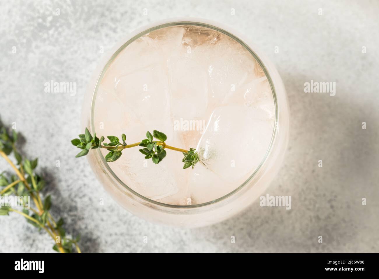 Boozy Pink Rose Wine Spritzer with Ice and Thyme Stock Photo - Alamy