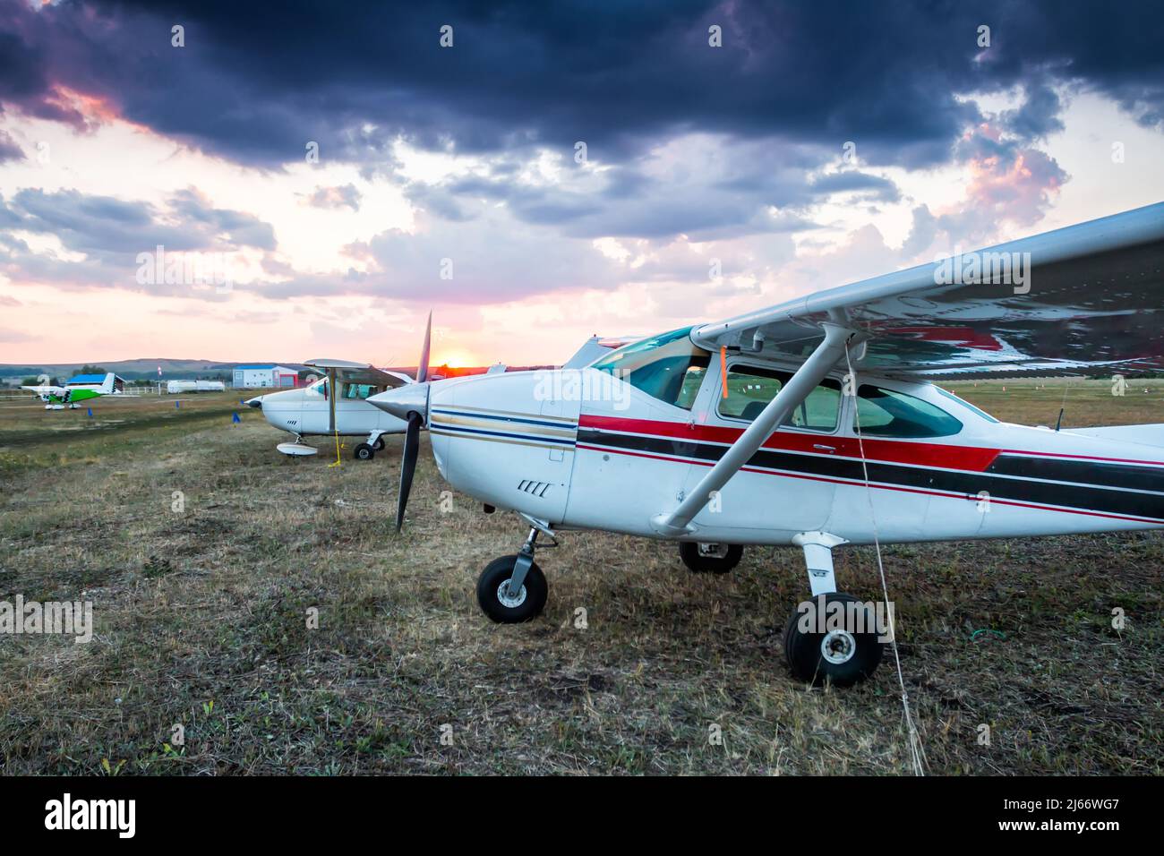 Small private airplanes parked at the airfield at scenic sunset Stock ...