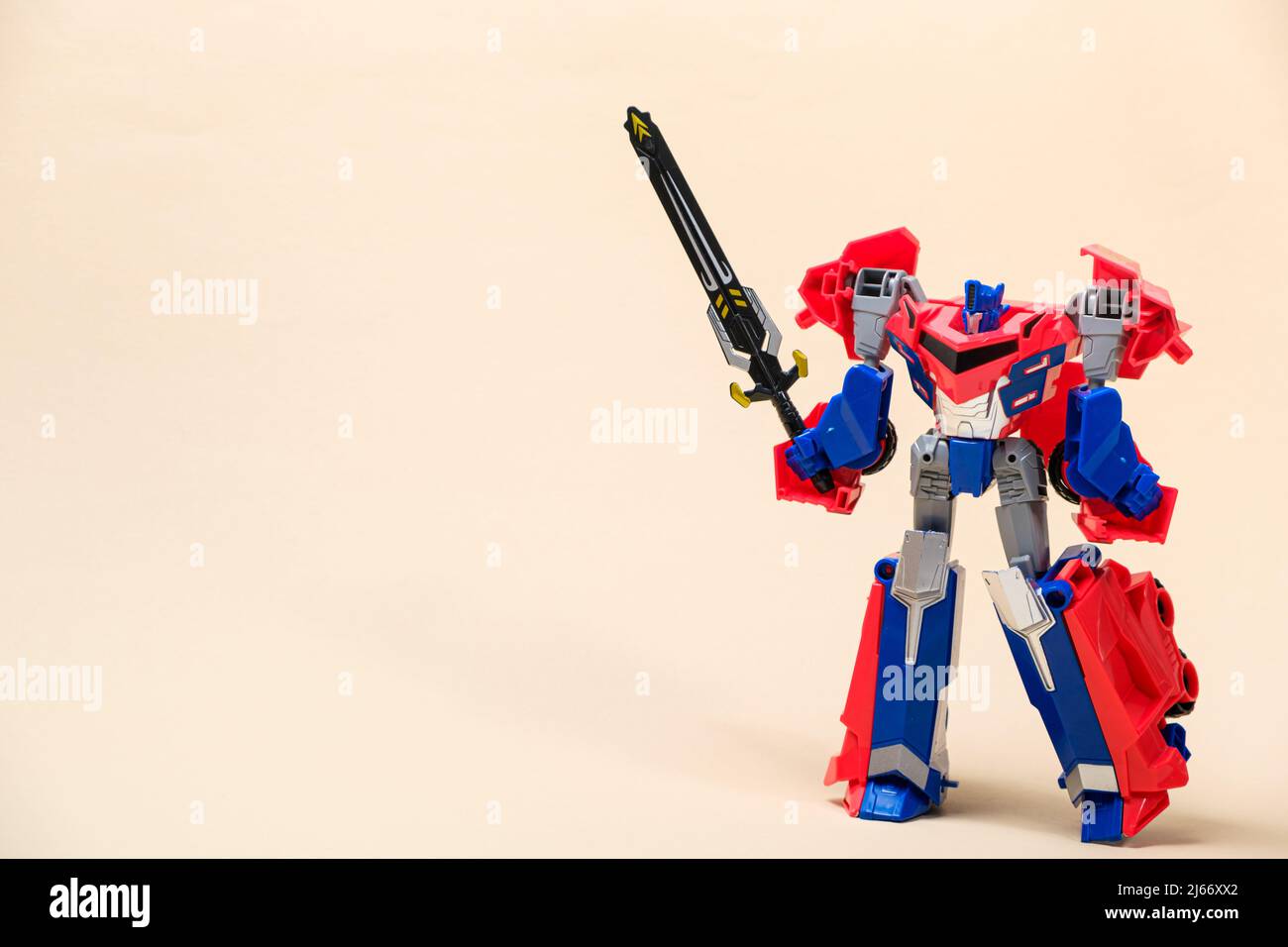 Robot transformer red and blue on a beige background with space for ...
