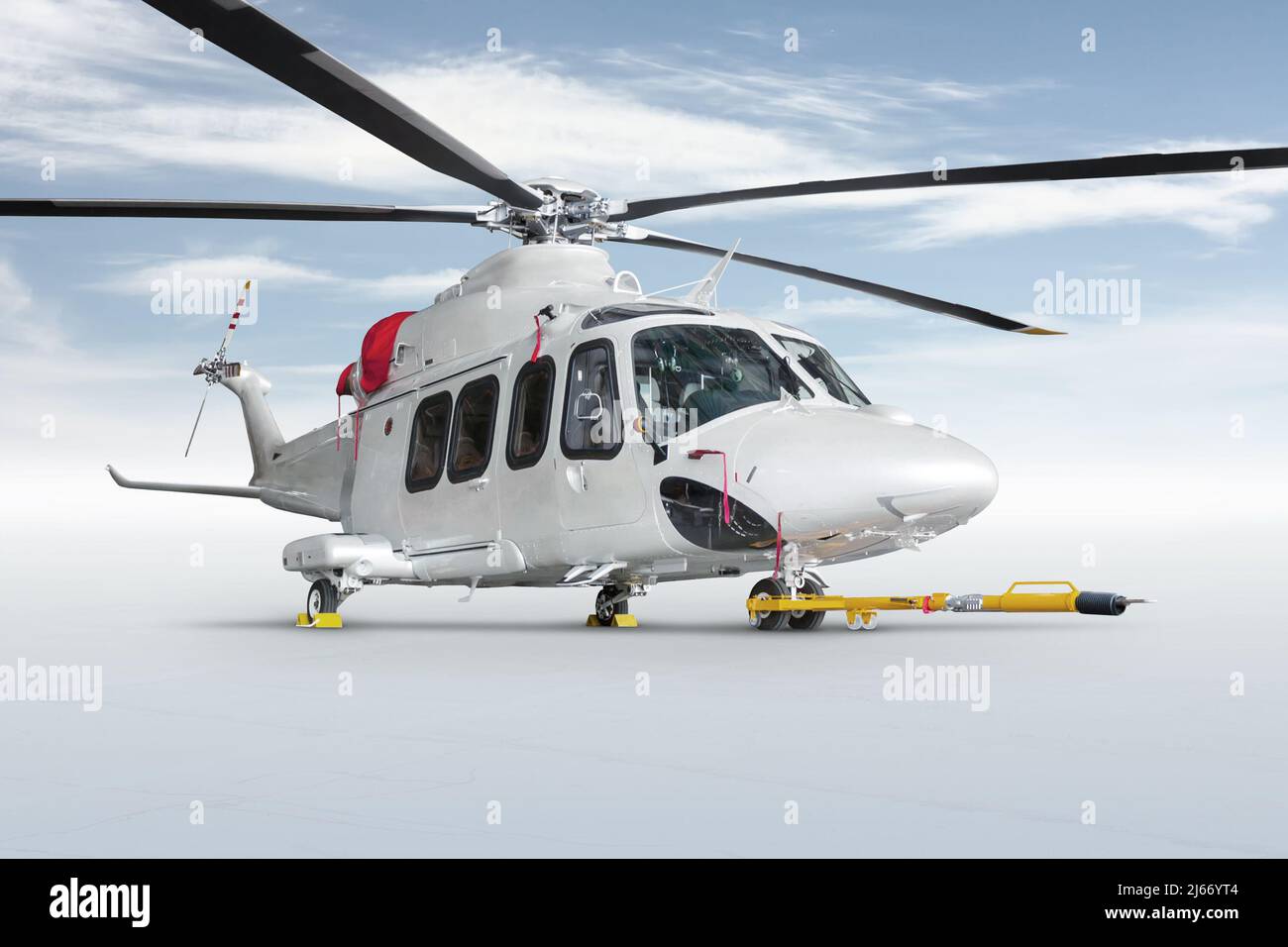 White luxury passenger helicopter with towbar isolated on bright ...