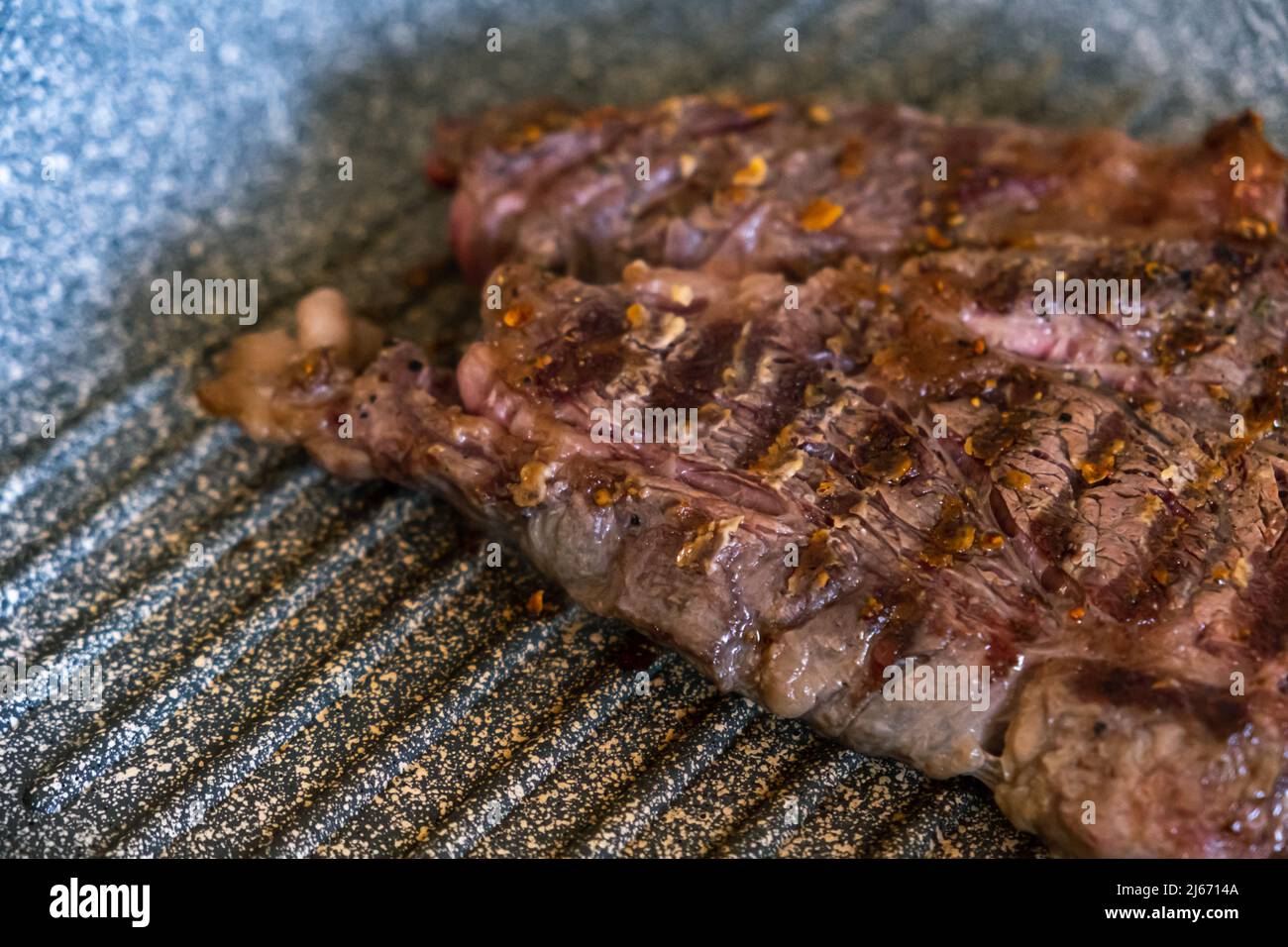 Juicy beef meat steak cooking on griddle pan at professional kitchen ...