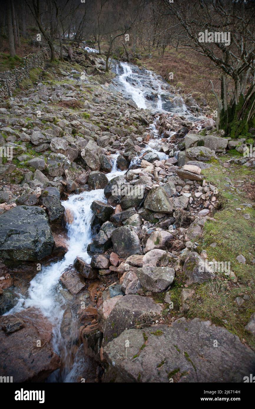 A waterfall flowing into Lake Buttermere, Cumbria in the UK Stock Photo ...