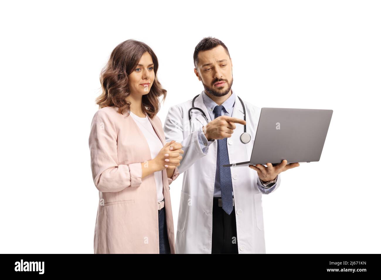 Doctor pointing at a laptop computer and standing with a young female ...