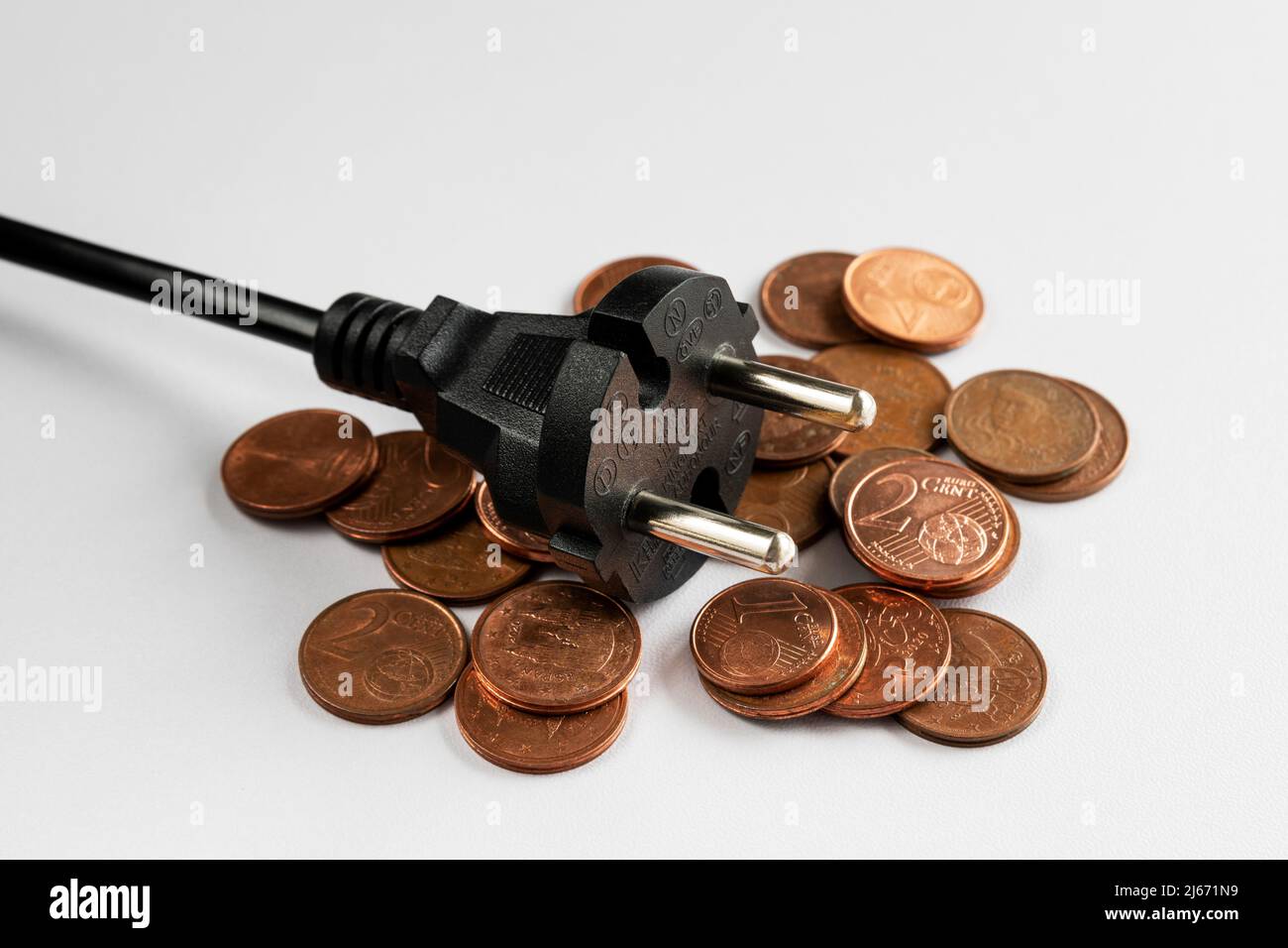 Black plug on coins and white background,cost of electricity and ...