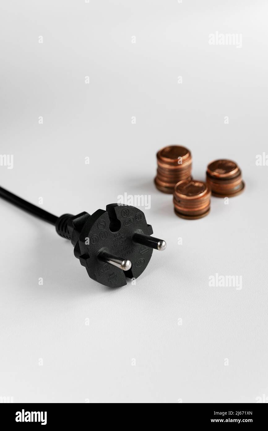 Black plug on white background,cost of electricity and expensive energy ...