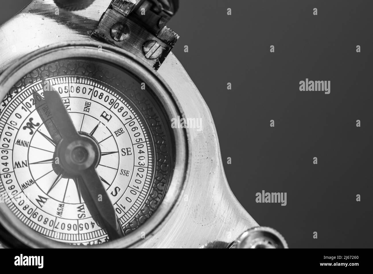 Detail of an antique maritime bronze solar compass in black and white ...